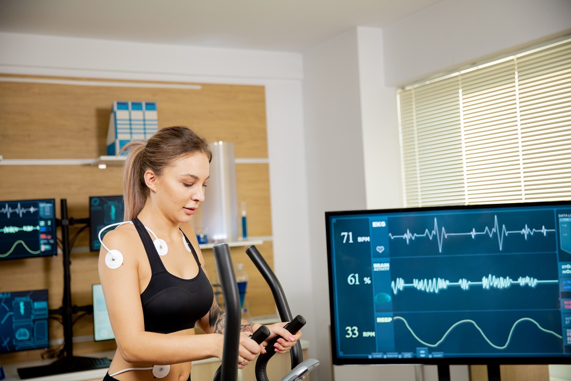 Female athlete who makes a physical effort on the stepper and has ...